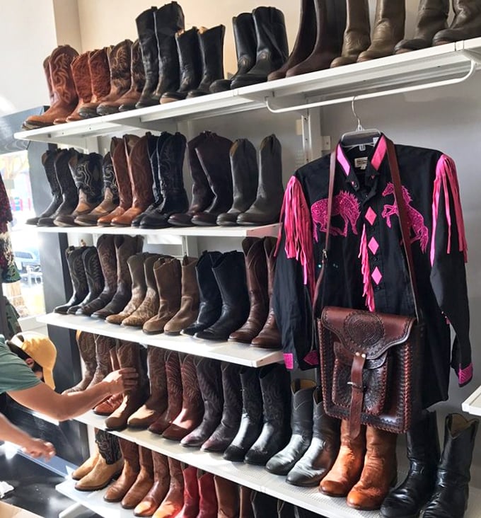 These aren't just cowboy boots—they're a leather library of American West fashion history, with that show-stopping pink-fringed jacket as the exclamation point.