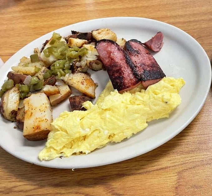 The breakfast trinity: perfectly scrambled eggs, home fries with green peppers, and sausage with just the right amount of char.