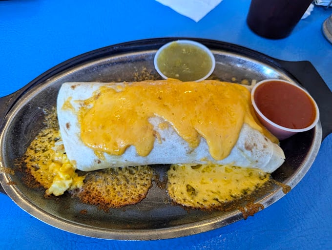 The breakfast burrito in its natural habitat – smothered in cheese and flanked by both red and green chile. Christmas comes daily in New Mexico.
