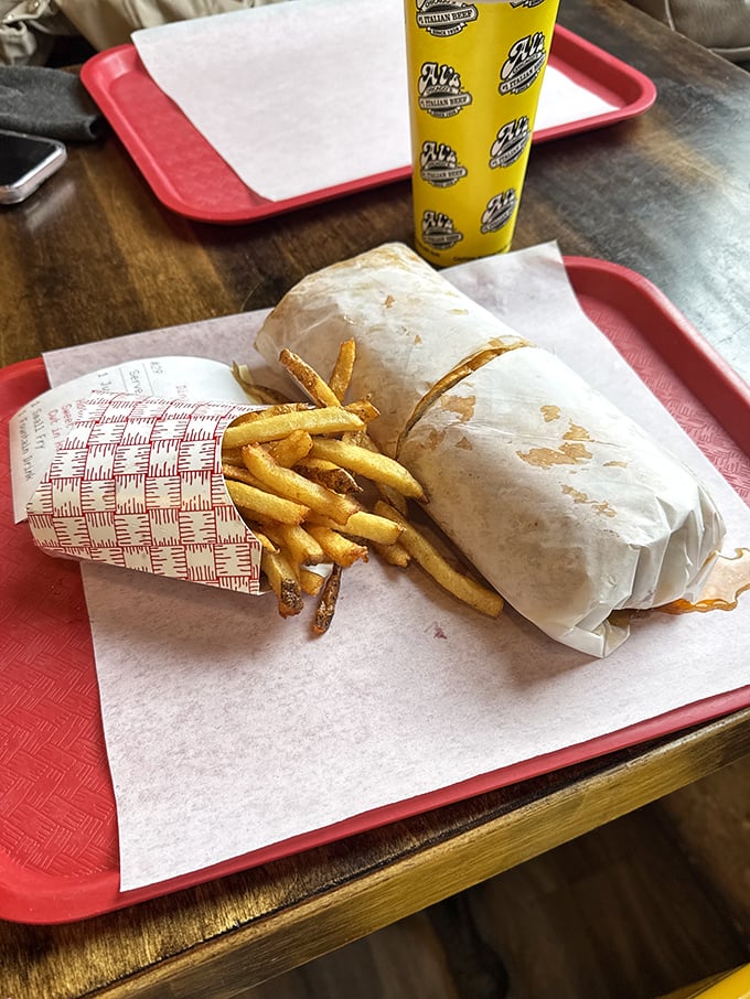 The classic Chicago dog in its natural habitat—nestled beside golden fries, wearing its yellow mustard jacket with pride.