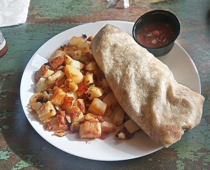 This breakfast burrito isn't just a meal, it's a commitment – stuffed with morning goodness and served with potatoes that could make an Idaho farmer proud.