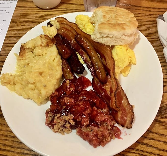 Breakfast that means business – scrambled eggs, bacon, and what might be the world's most perfect biscuit waiting for your attention.