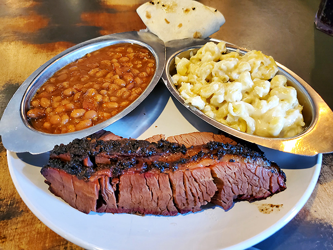 Brisket, beans, and mac & cheese—the holy trinity of barbecue satisfaction that proves comfort food is the universal language of happiness.