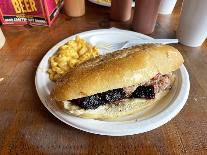 This brisket cheesesteak isn't just a sandwich – it's architecture, engineering, and art all wrapped in a perfect roll with mac and cheese standing guard.