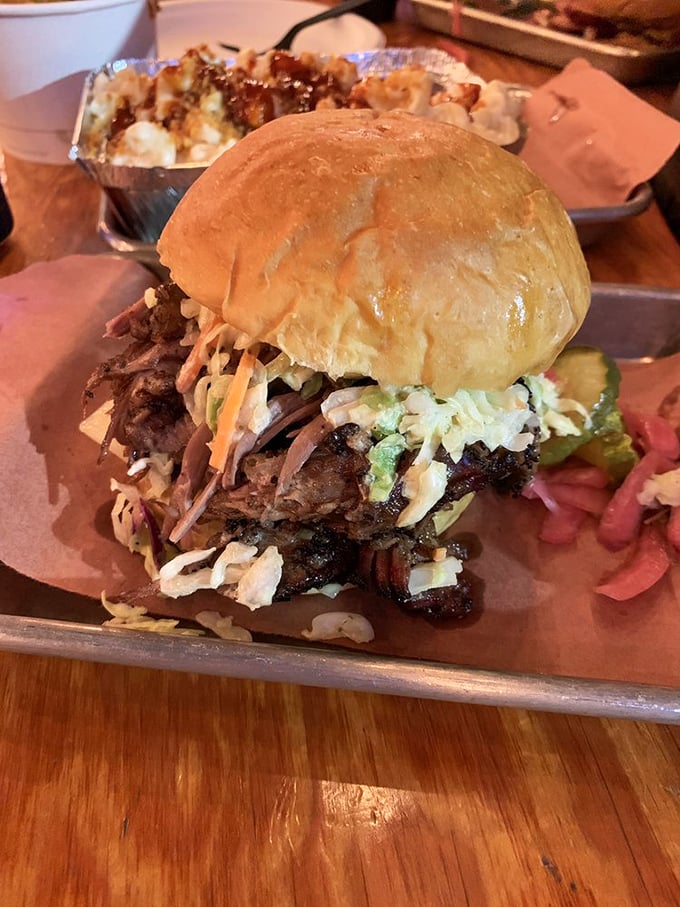 This isn't just a sandwich—it's architecture. Layers of brisket and coleslaw create a towering monument to what happens when meat meets patience.