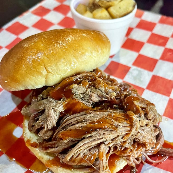 This isn't just a sandwich; it's a monument to patience. Hours of smoking transformed tough pork into this glistening masterpiece that practically begs to be devoured.