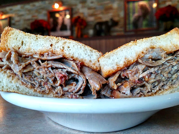 This isn't just a sandwich; it's an architectural marvel of smoked meat. The kind that makes conversation impossible until the last bite.