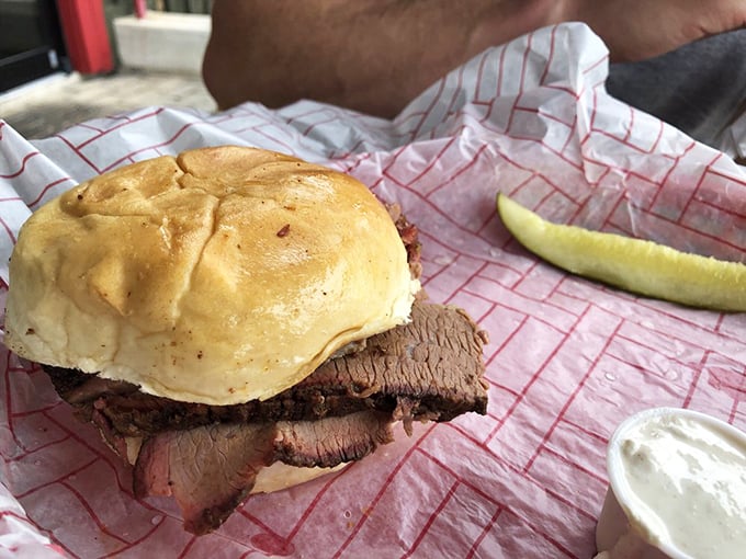 The brisket sandwich – where pillowy bun meets smoky, tender beef in a relationship so perfect it should have its own reality show.