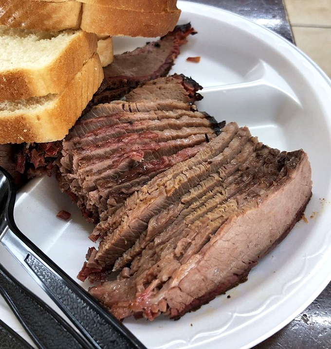 Brisket sliced so perfectly it could make a geometry teacher weep. The pink smoke ring isn't just color—it's a barbecue badge of honor.