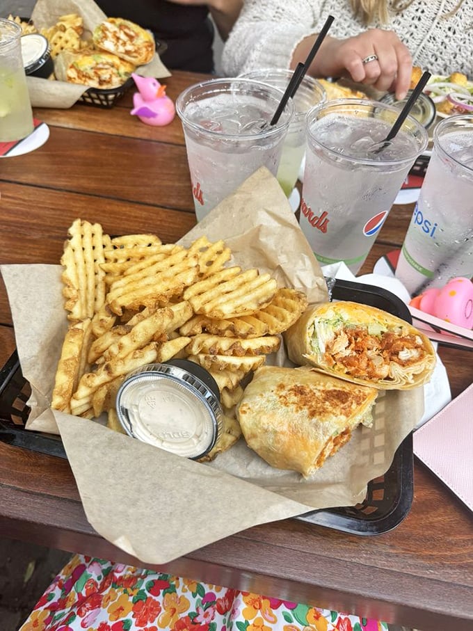Waffle fries and wraps—the dynamic duo of lakeside dining. That little pink rubber duck knows it's watching over culinary greatness.