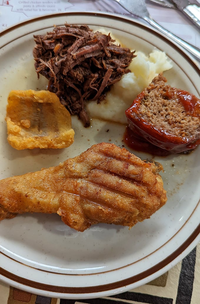 A buffet plate showcasing the greatest hits album of Amish country cooking – meat, potatoes, and zero pretension.