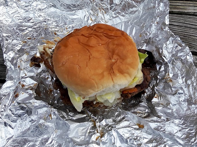 Wrapped in foil like a precious gift, this burger reveals itself layer by layer—each bite a perfect balance of beef, cheese, and fresh toppings.