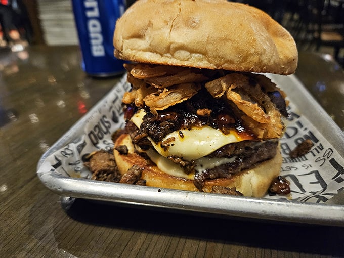 This isn't just a burger—it's an architectural marvel of beef, cheese, and toppings that requires both hands and possibly a building permit.