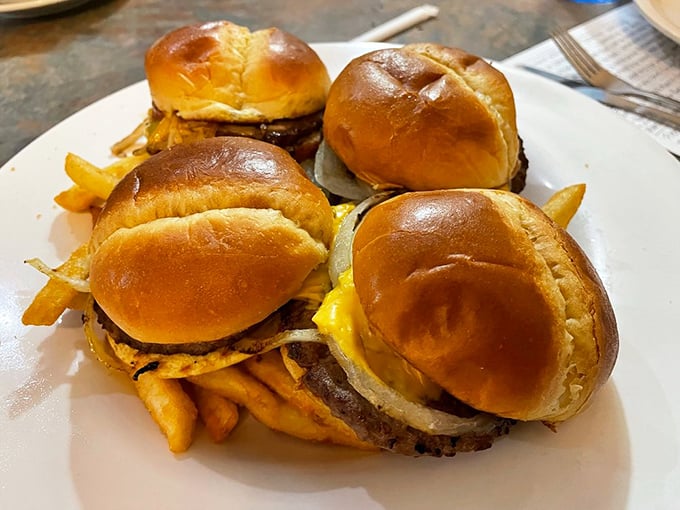 These aren't just sliders – they're a quartet of perfectly grilled mini-masterpieces. Golden buns, melty cheese, and fries that refuse to play second fiddle.