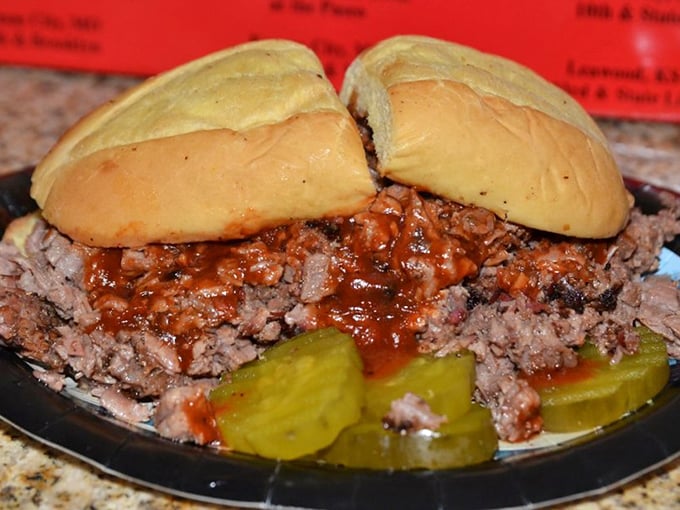 The burnt ends sandwich—Kansas City's gift to humanity—sits on a throne of pickles, its smoky, caramelized edges practically begging you to ignore your table manners.