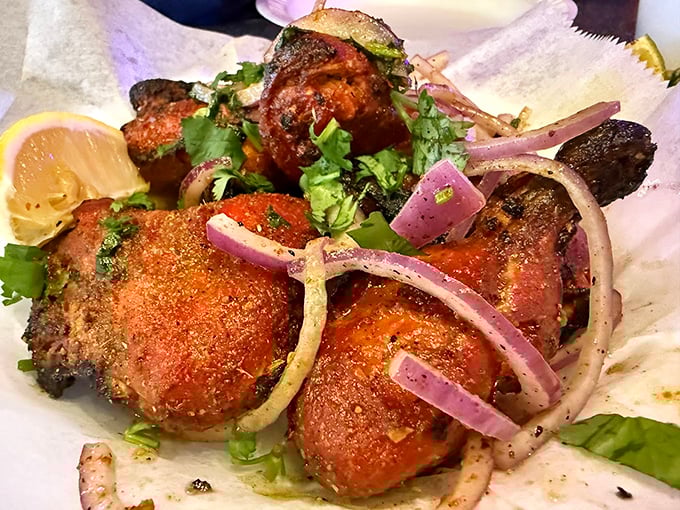 Tandoori chicken that's had a proper introduction to fire—charred edges, vibrant color, and a sprinkle of herbs that means business.