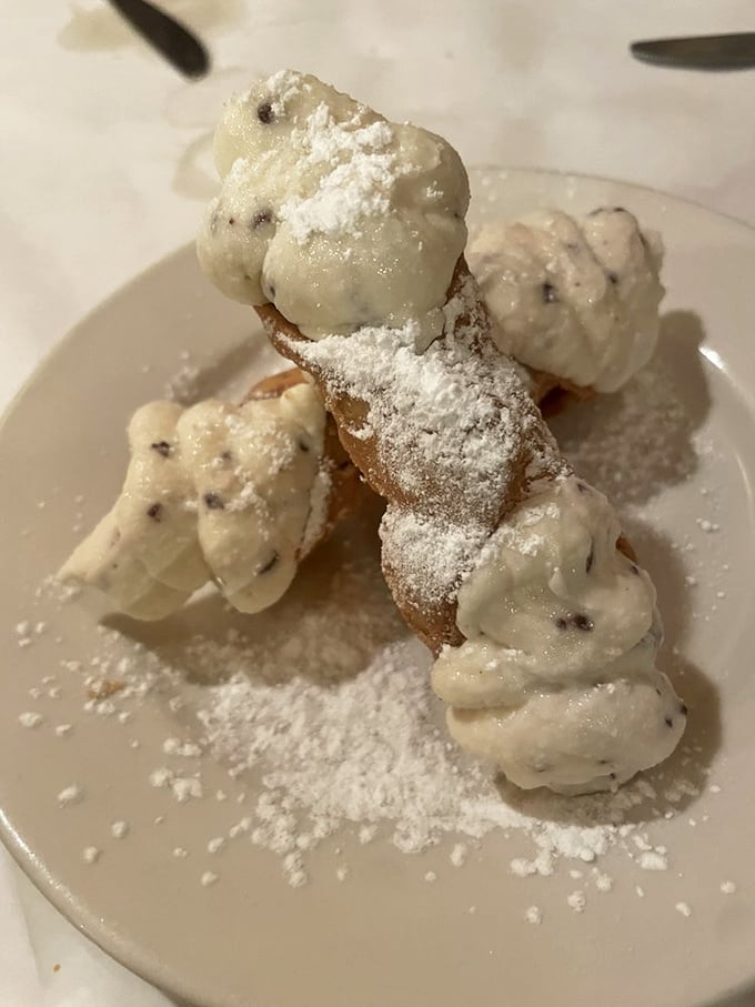 This cannoli doesn't just have filling – it has attitude. The crisp shell shatters with purpose, revealing a sweetened ricotta that's impossibly light yet deeply satisfying.