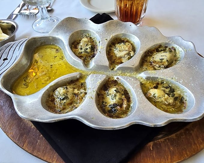 Chargrilled oysters swimming in butter and herbs—proof that sometimes the best things in life require a bib and zero dignity.