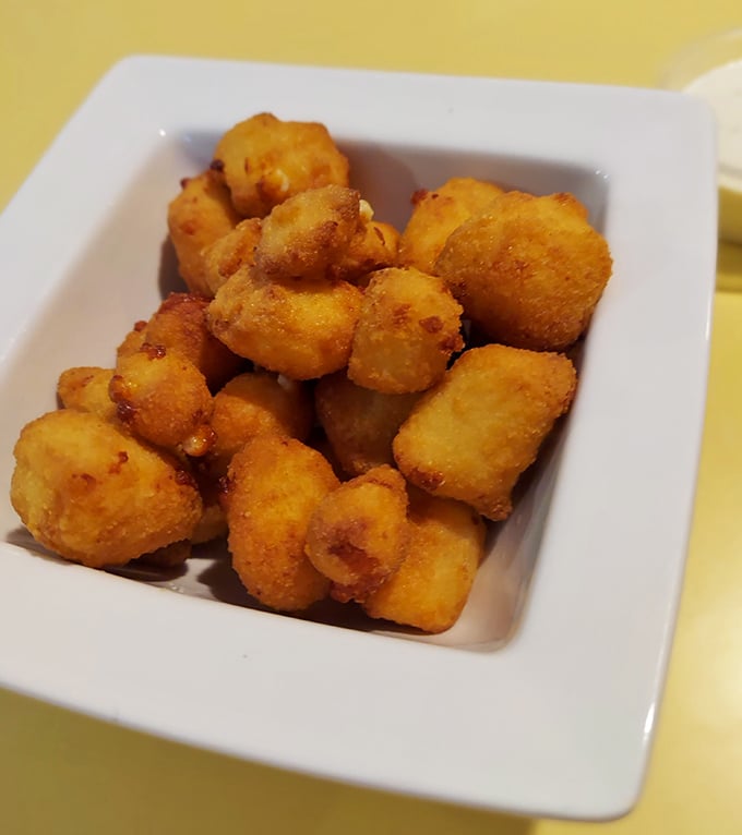 These cheese curds aren't just fried—they're transformed into golden nuggets of happiness that squeak their way into your heart.
