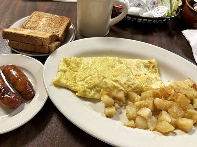 Simple pleasures done right – a perfectly folded omelet alongside home fries that strike that magical balance between crispy and tender.