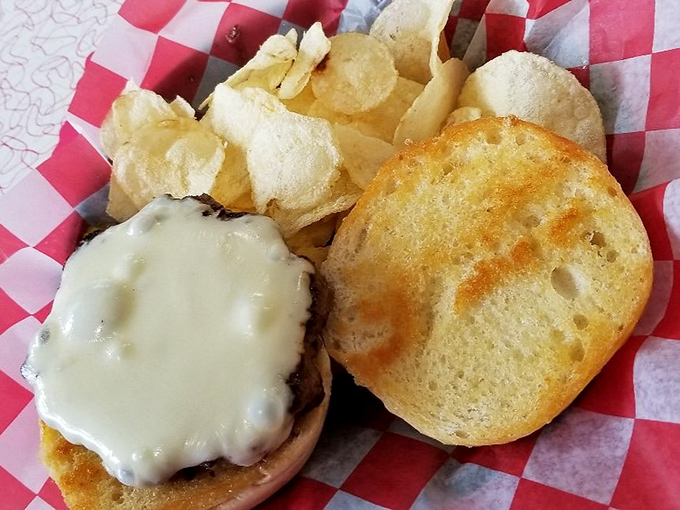 A proper diner cheeseburger doesn't need fancy toppings or pretentious presentation—just honest ingredients on a perfectly toasted bun with crispy chips.