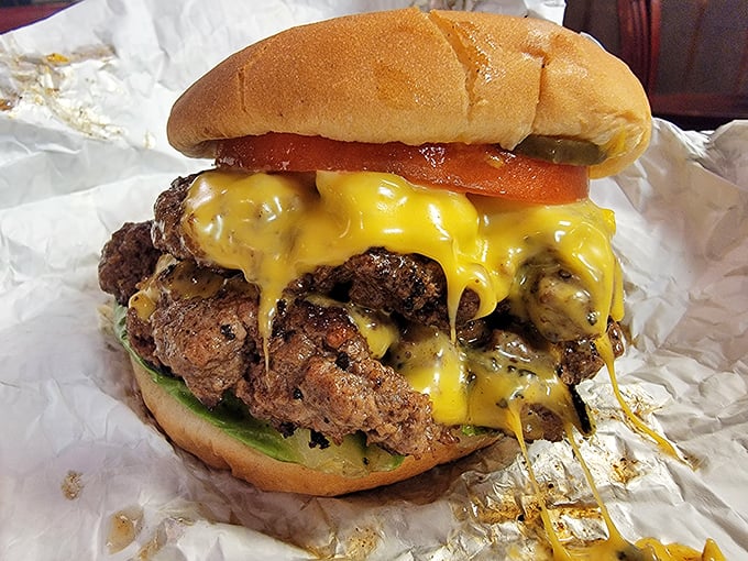 Behold the cheeseburger that launched a thousand road trips – juicy, messy, and demanding to be eaten with both hands and zero regrets.