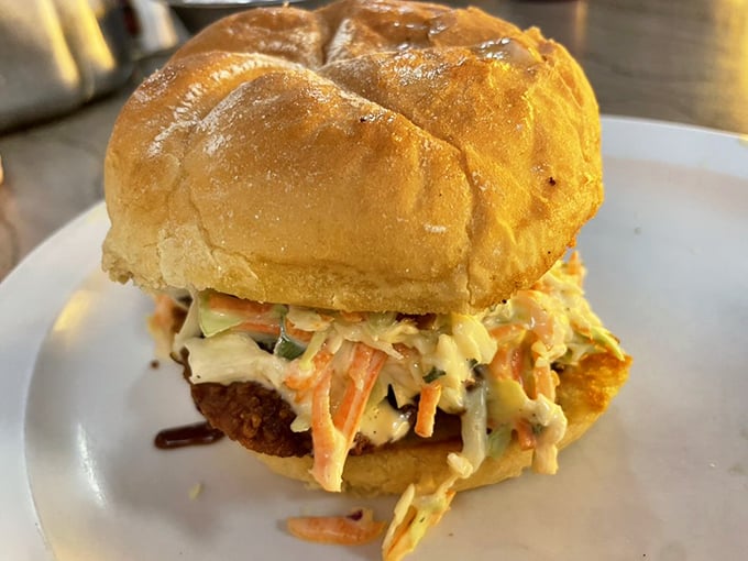 This isn't just a chicken sandwich—it's a masterpiece of textures and flavors, with creamy slaw providing the perfect counterpoint to the crispy chicken beneath.