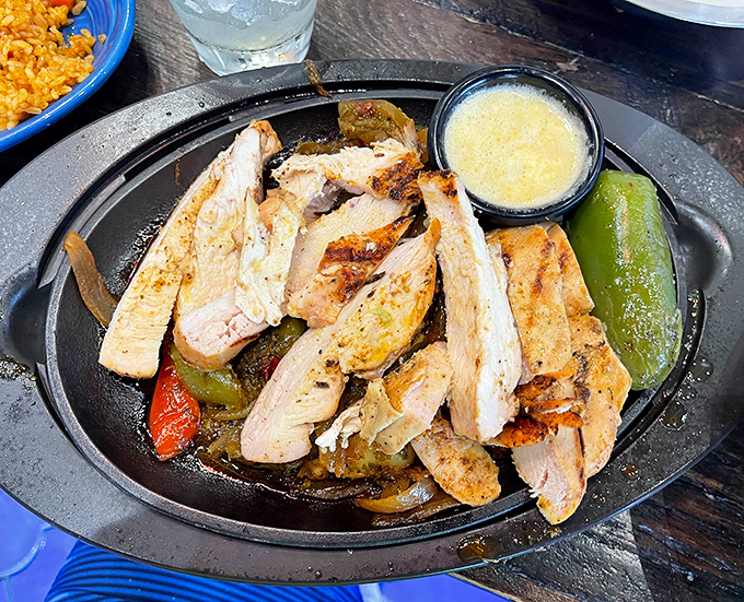 Sizzling chicken fajitas that announce their arrival before you see them. The sound alone is enough to make neighboring tables develop immediate order envy.