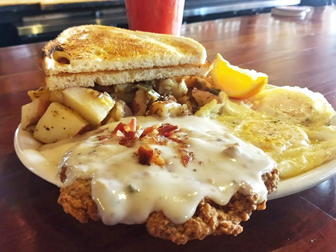 Country-fried steak smothered in gravy with a side of golden toast – comfort food that hugs your soul before it clogs your arteries.