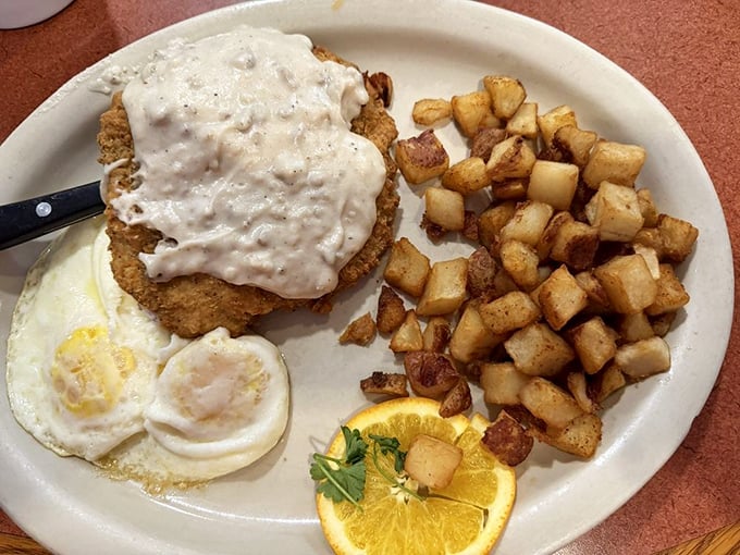 Country-fried steak smothered in gravy alongside perfectly crispy home fries – the breakfast equivalent of a warm hug from your favorite aunt.