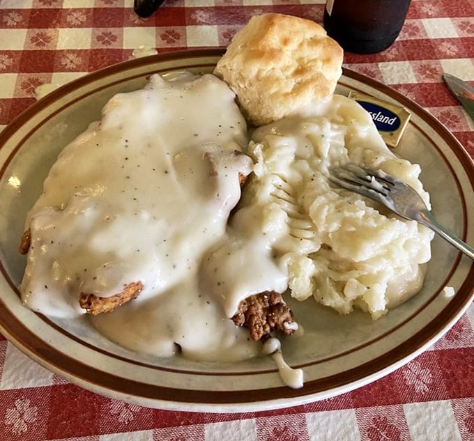 Chicken fried steak swimming in cream gravy with mashed potatoes—a plate that answers the question, "What does Texas taste like?"