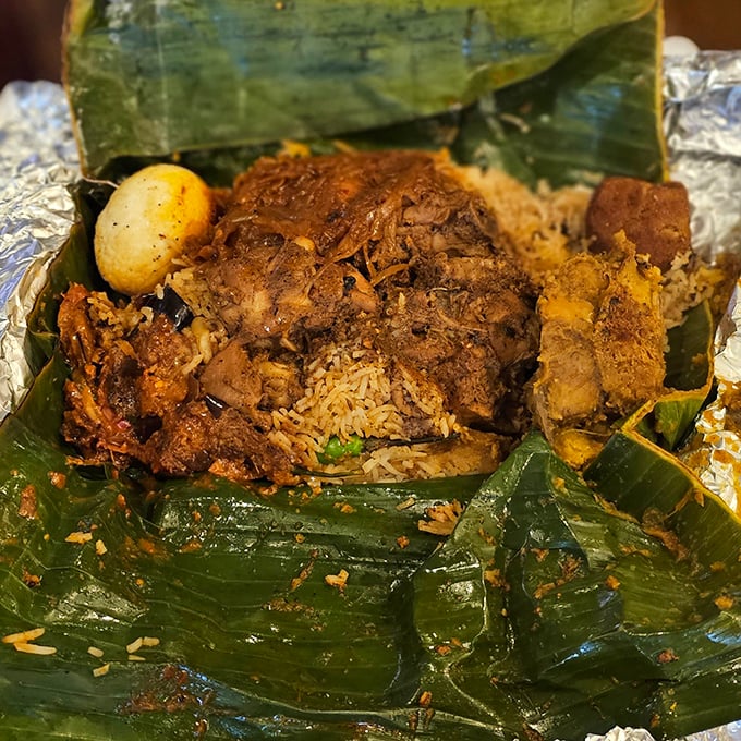 Unwrapping lamprais is like opening a present on your taste buds—banana leaf-steamed rice and curry creating aromatic magic that no gift box could contain.