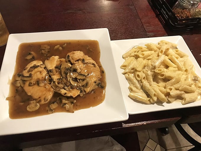 Chicken marsala swimming in mushroom gravy beside creamy pasta – comfort food that could solve world peace.