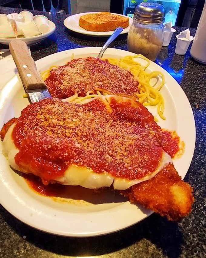 Chicken Parmesan that doesn't mess around – crispy cutlets swimming in marinara and melted cheese atop a bed of spaghetti.
