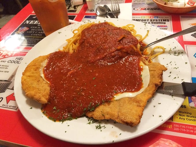Chicken parmesan that doesn't know the meaning of restraint – a golden-fried cutlet swimming happily in a sea of marinara.