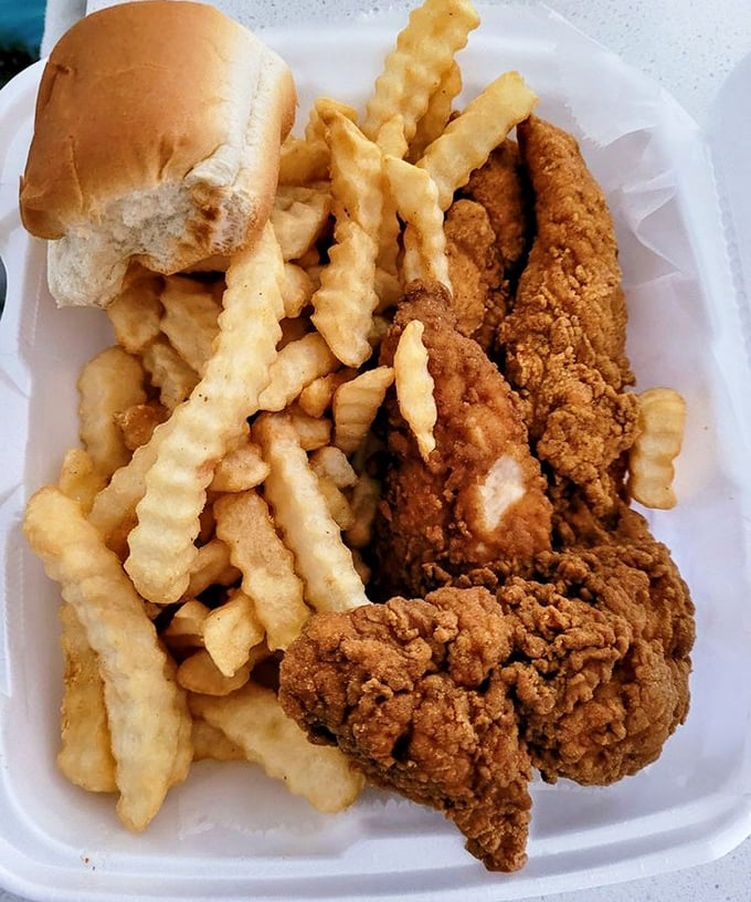 Crinkle-cut fries and chicken that would make Colonel Sanders weep with envy. The roll isn't just a garnish—it's there to soak up every last bit of flavor.