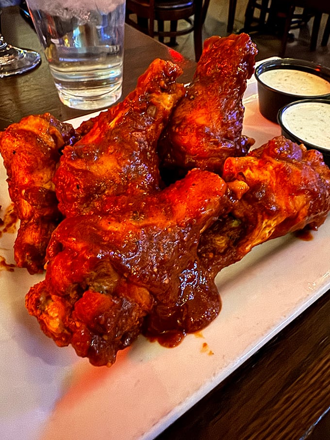 These wings aren't just coated in sauce—they're baptized in it. The kind of messy indulgence that makes you grateful for extra napkins and forgiving friends.