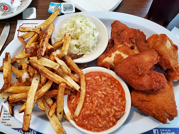 The complete Barberton chicken experience: crispy chicken, tangy hot sauce, vinegary slaw, and hand-cut fries that could start their own fan club.