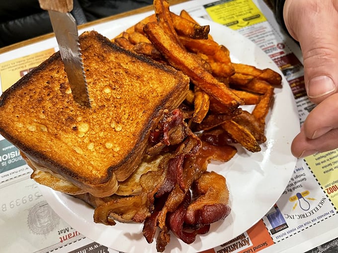 Behold the grilled sandwich in its natural habitat—perfectly toasted bread giving way to melty cheese and bacon that's achieved that magical crisp-yet-chewy state of perfection.