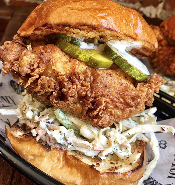 The chicken sandwich that launched a thousand cravings—crispy chicken, tangy pickles, and creamy slaw stacked on a toasted bun. Napkins required, regrets impossible.