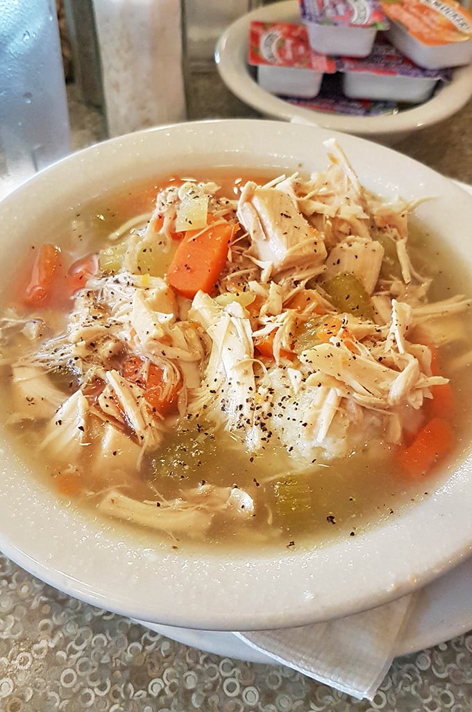 Chicken soup that could heal not just colds but existential crises – chunky, aromatic, and made with grandmotherly precision.