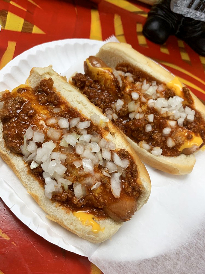 Chili, cheese, and onions piled high on perfectly grilled franks – messy, glorious, and absolutely worth every napkin you'll need to use here.