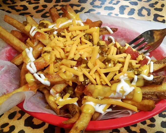 Loaded fries that make you question why you'd ever eat them plain again—a glorious mess of cheese, chili, and condiments worth every napkin.