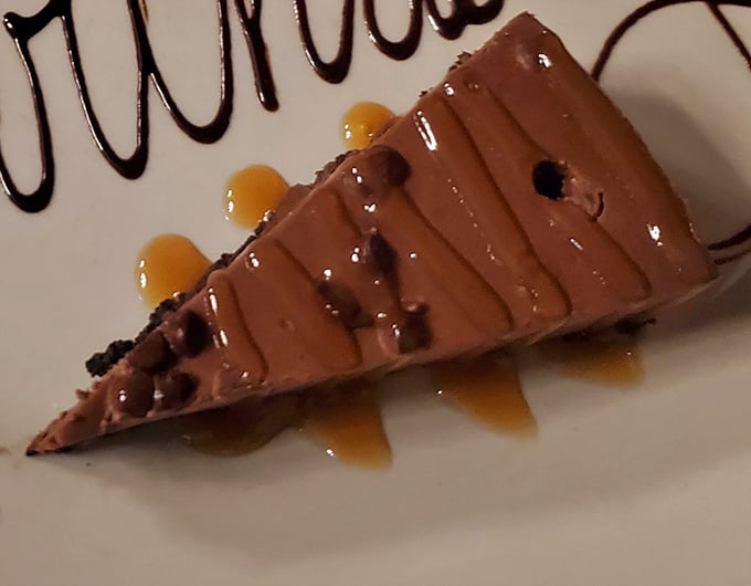 Even dessert maintains the steakhouse's commitment to indulgence. This chocolate cheesecake doesn't need a fancy pedigree—it speaks the universal language of "yes, please."