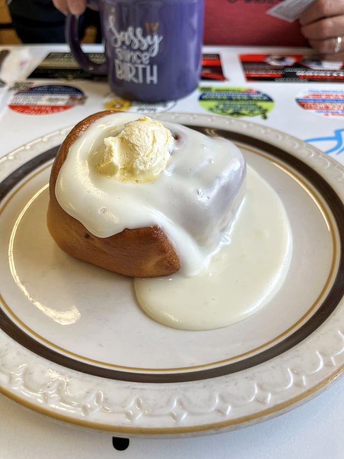 This cinnamon roll isn't just topped with icing—it's wearing a crown of melting butter like it knows it's breakfast royalty.