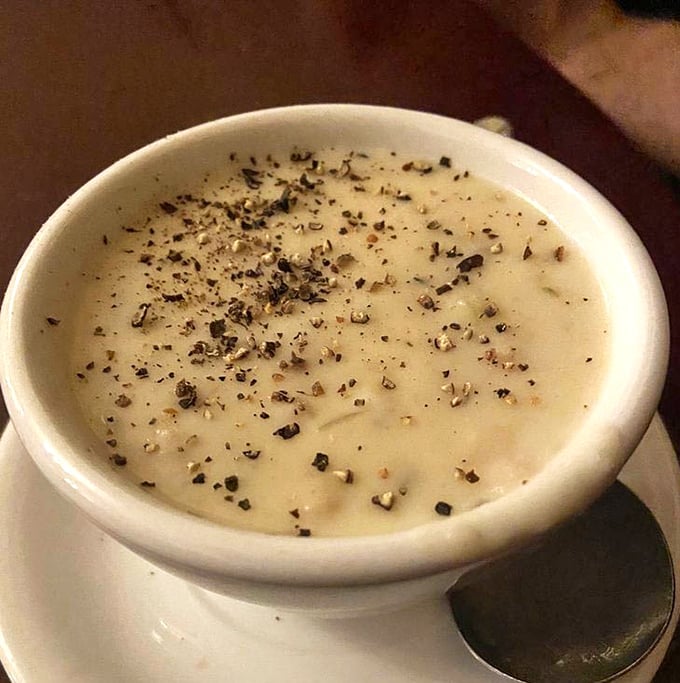 This isn't just clam chowder—it's a creamy canvas of comfort, waiting for that final artistic touch of freshly cracked pepper.