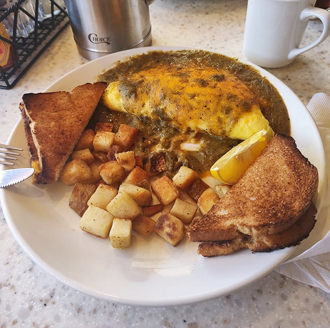 When green chile sauce blankets an omelet like this, you don't just eat breakfast—you experience a New Mexican morning ritual.