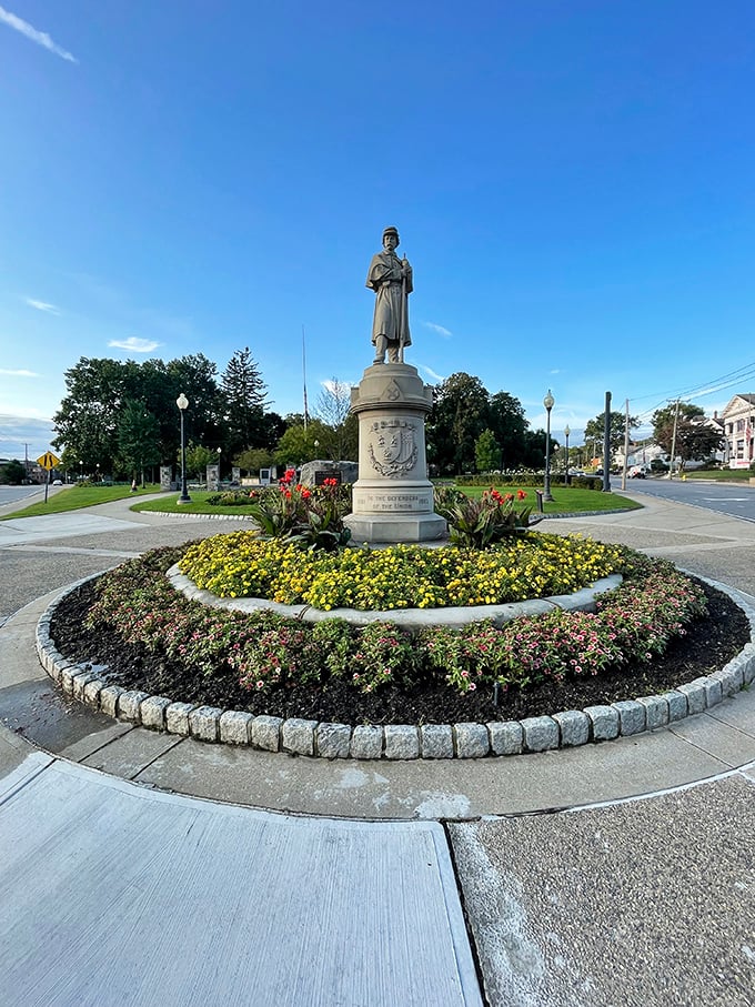The Civil War memorial at Coe Memorial Park stands proudly amid meticulously maintained flower beds—retirement eye candy that costs nothing to enjoy.