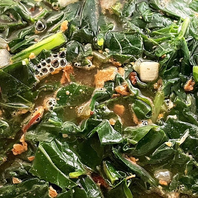 Collard greens shimmer with flavor, proving that vegetables absolutely belong at the barbecue table after all.