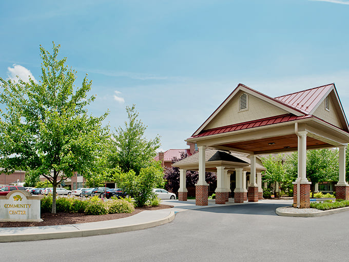 The community center entrance says "welcome home" more eloquently than any doormat, with architecture that balances grandeur and comfort.